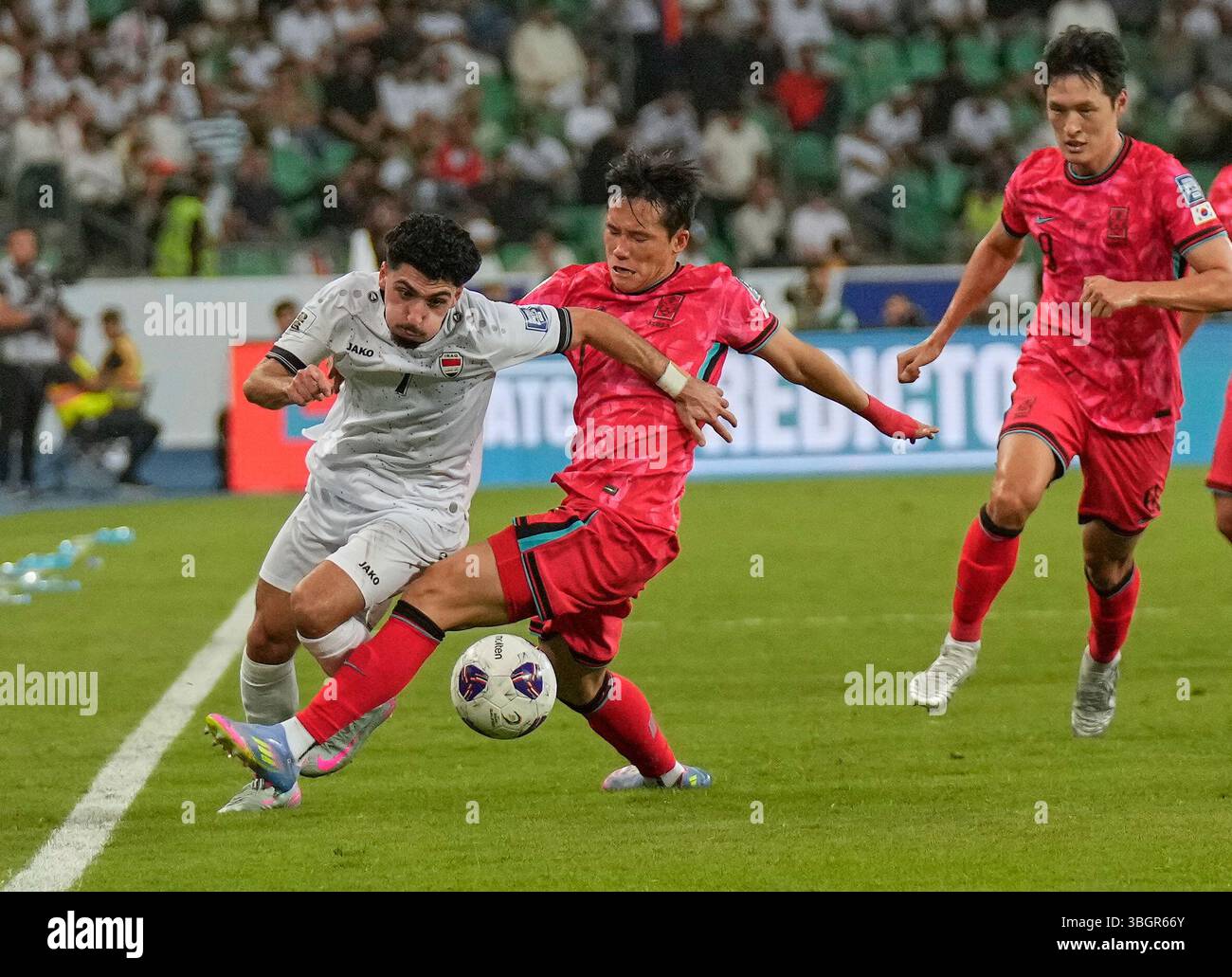 Iraq's Youssef Wali Amyn, left, fights for the ball during the Asian ...