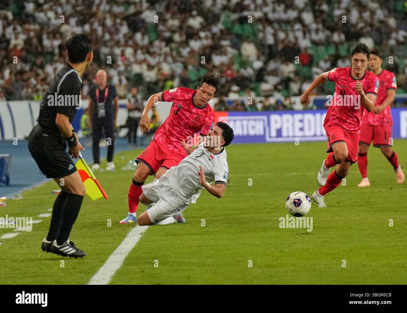 Iraq's Youssef Wali Amyn, center, grimaces in pain during the Asian ...
