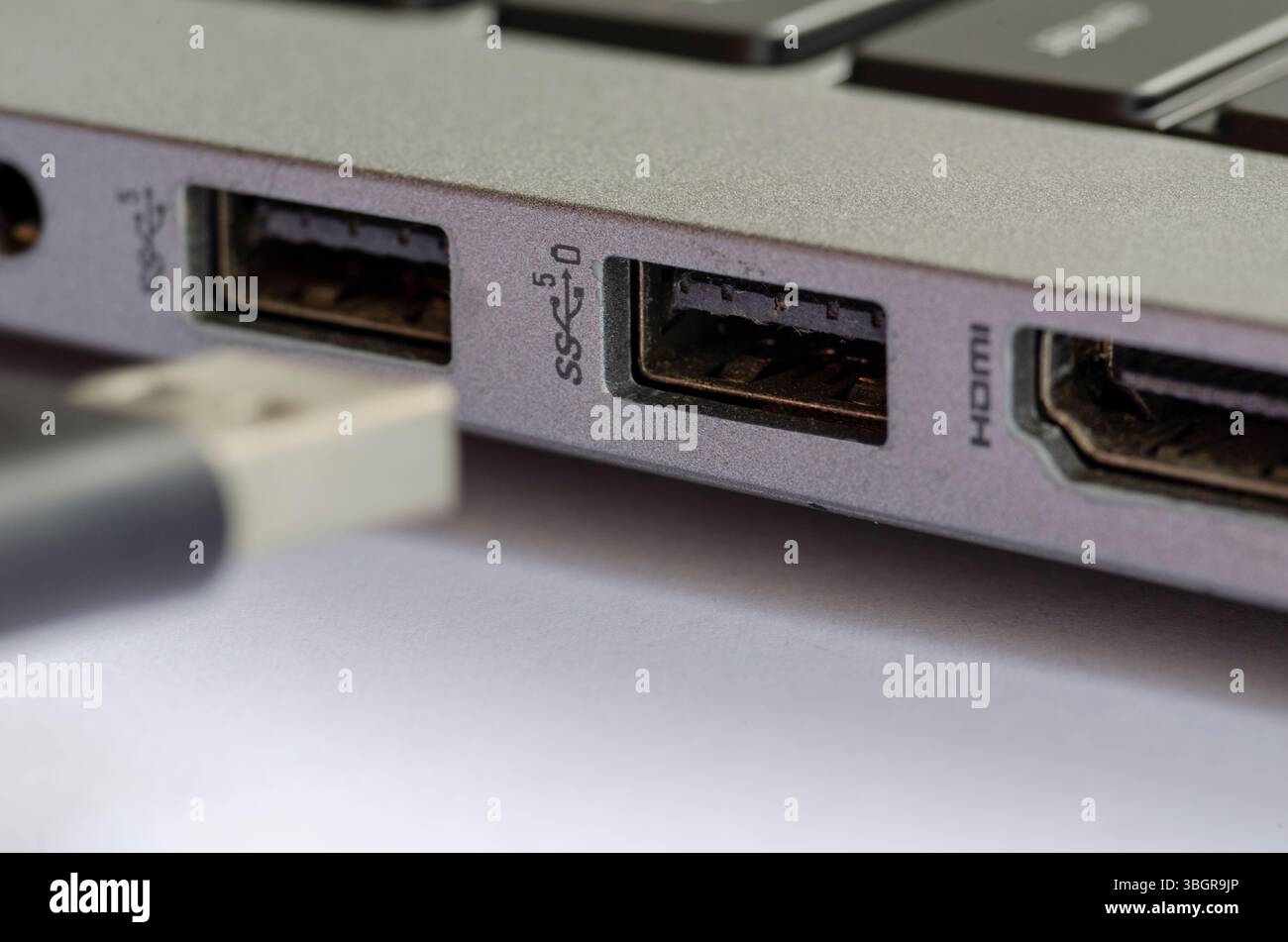 Hand inserting USB into laptop port demonstrating threat from unknown ...