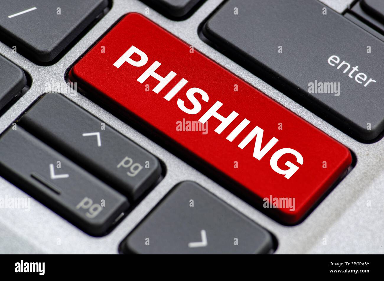 Phishing text on red keyboard key highlighting deceptive attempts to ...
