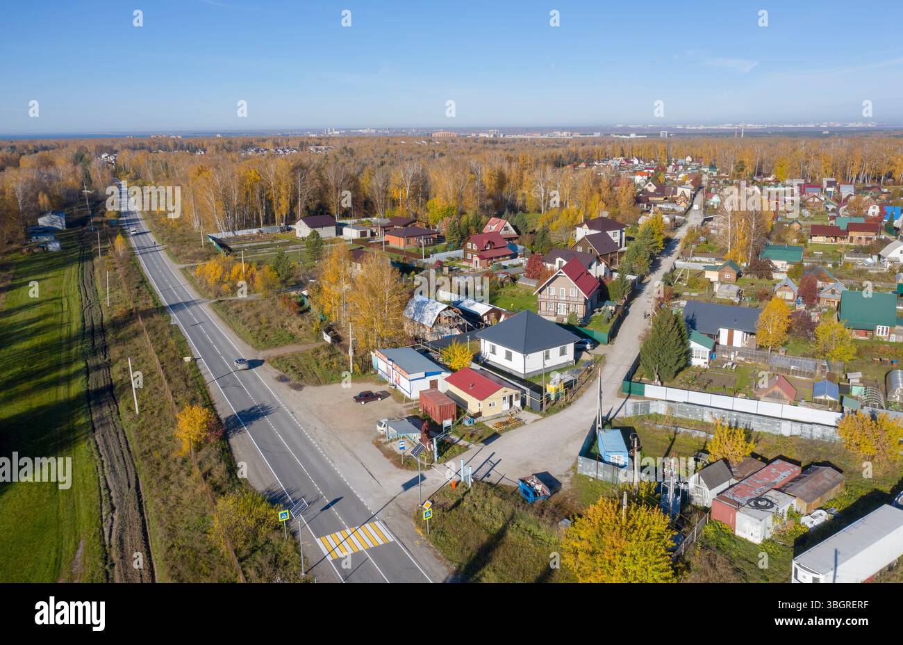Aerial view of summer cottages and the road to the city in the suburbs ...