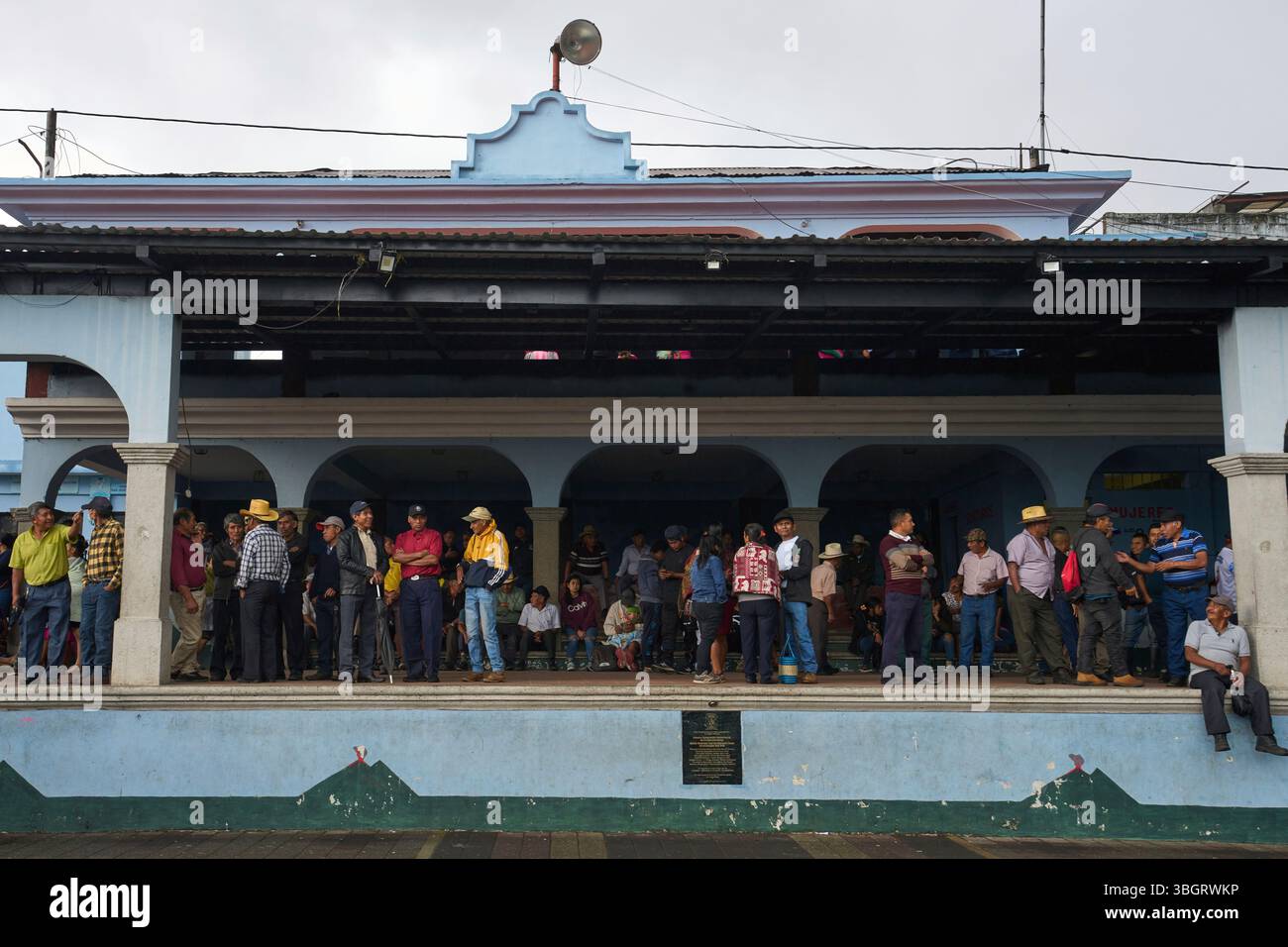 Families evacuated from the area surrounding the Fuego Volcano stand in ...