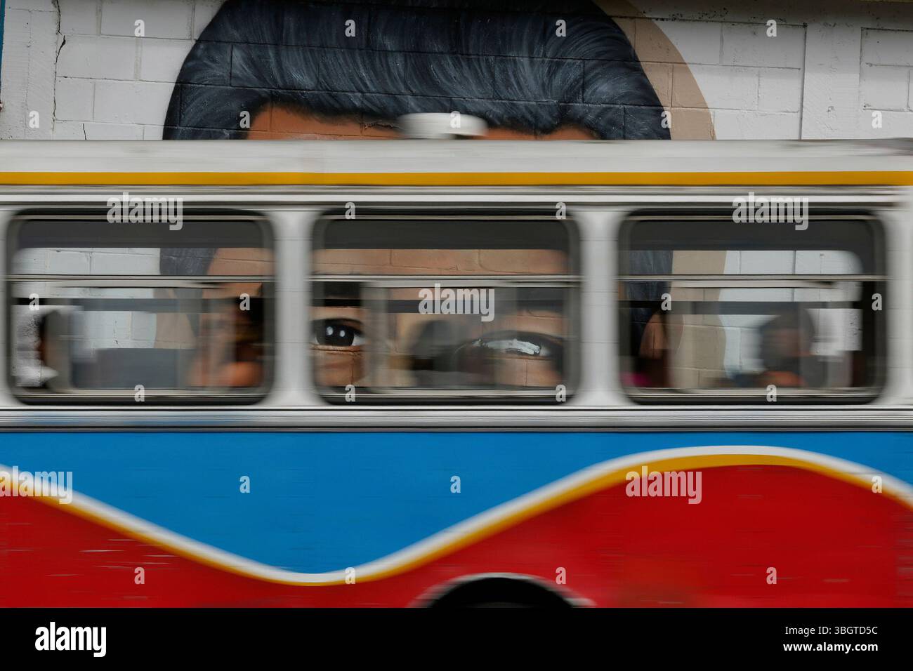 A public bus passes a mural of Venezuelan President Nicolas Maduro in ...