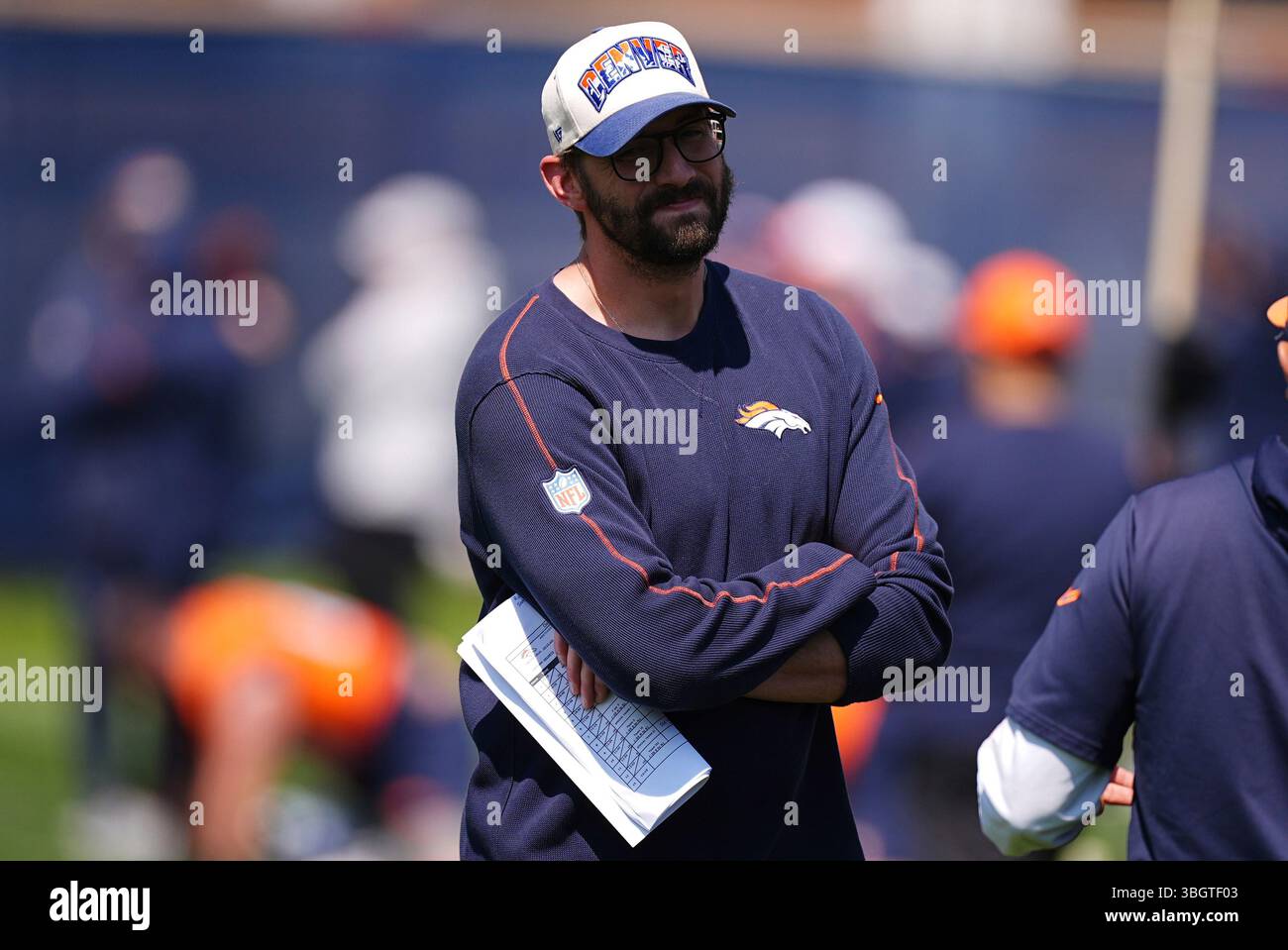 Denver Broncos quarterbacks coach Davis Webb looks on as players take ...