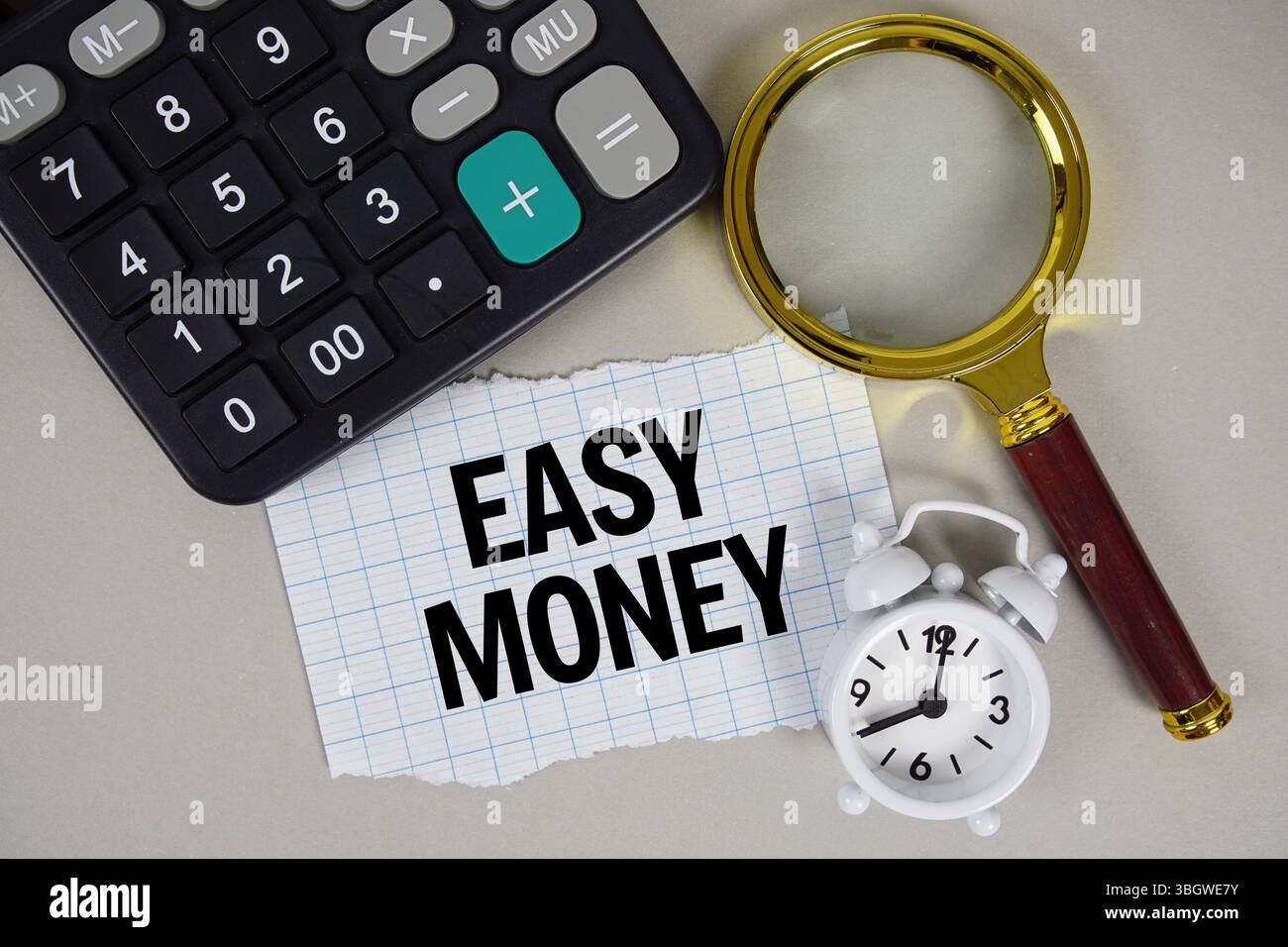 Easy Money text with alarm clock, magnifying glass anc calculator on ...