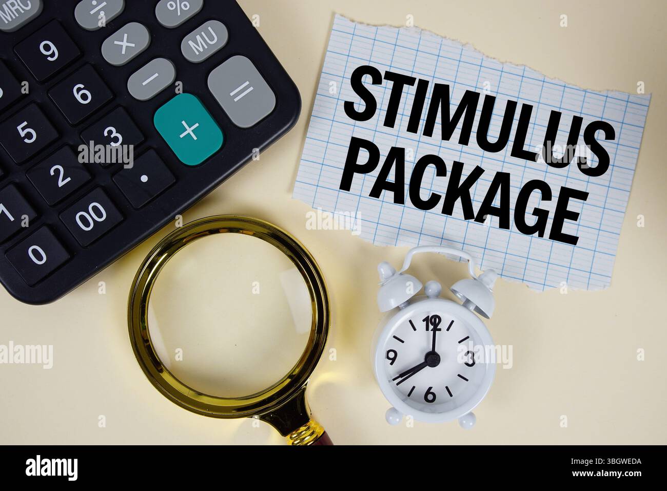 Stimulus Package text with alarm clock, magnifying glass anc calculator ...