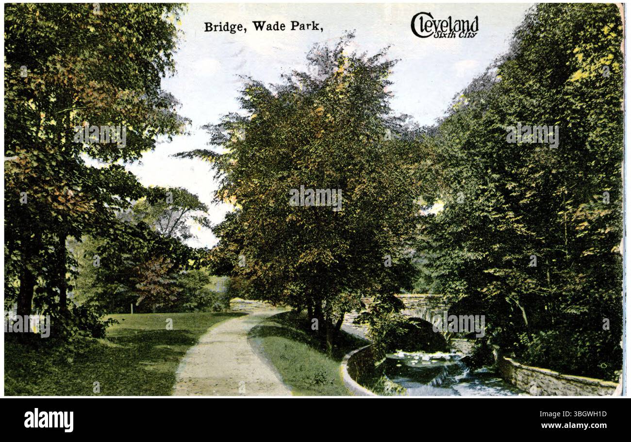 A 1915 colored photograph of a stone bridge over a stream in Wade Park ...