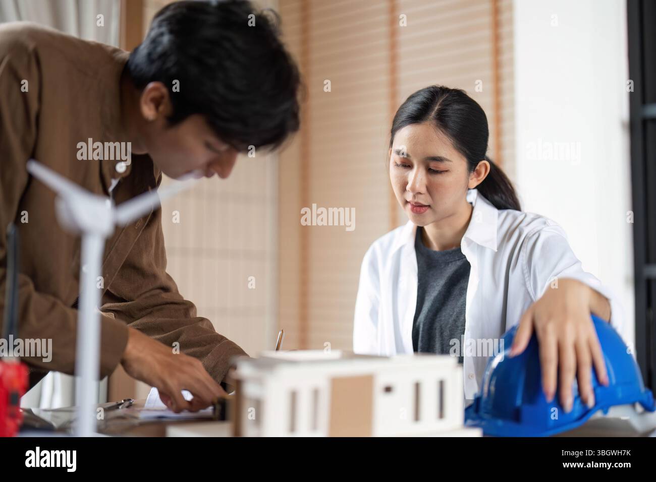 ESG Principles in Action. Young architects collaborating on sustainable ...