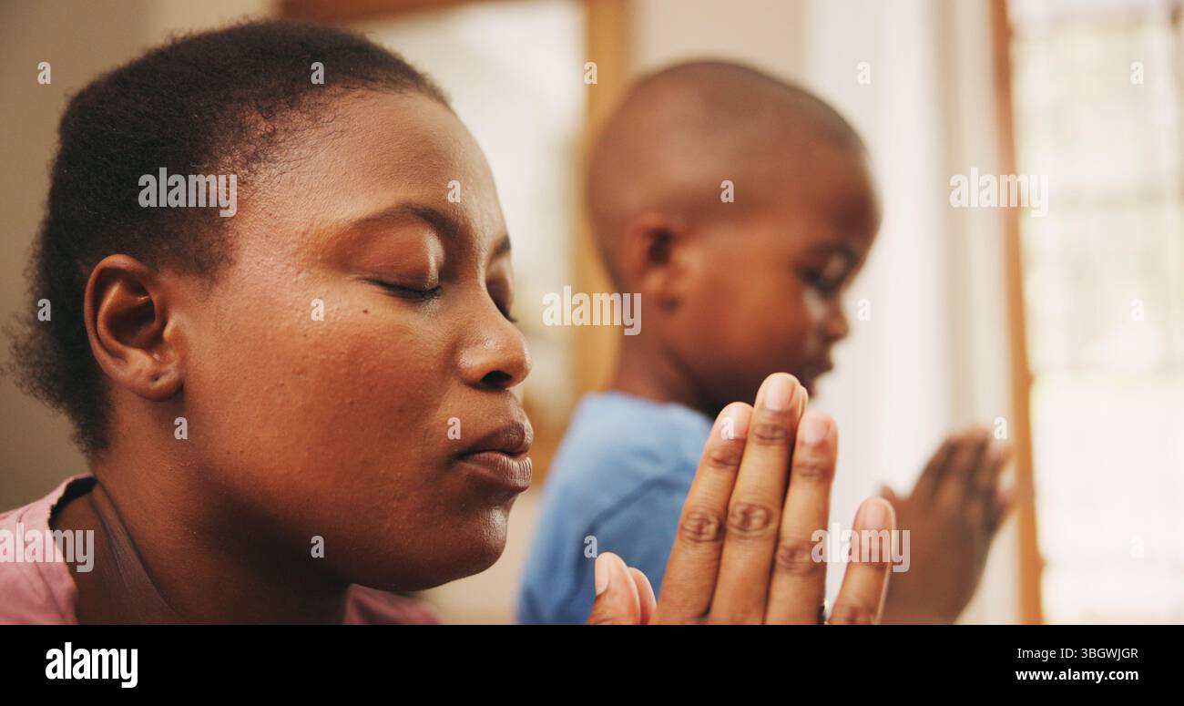 Praying, worship and black mother with kid in home for religion, praise ...