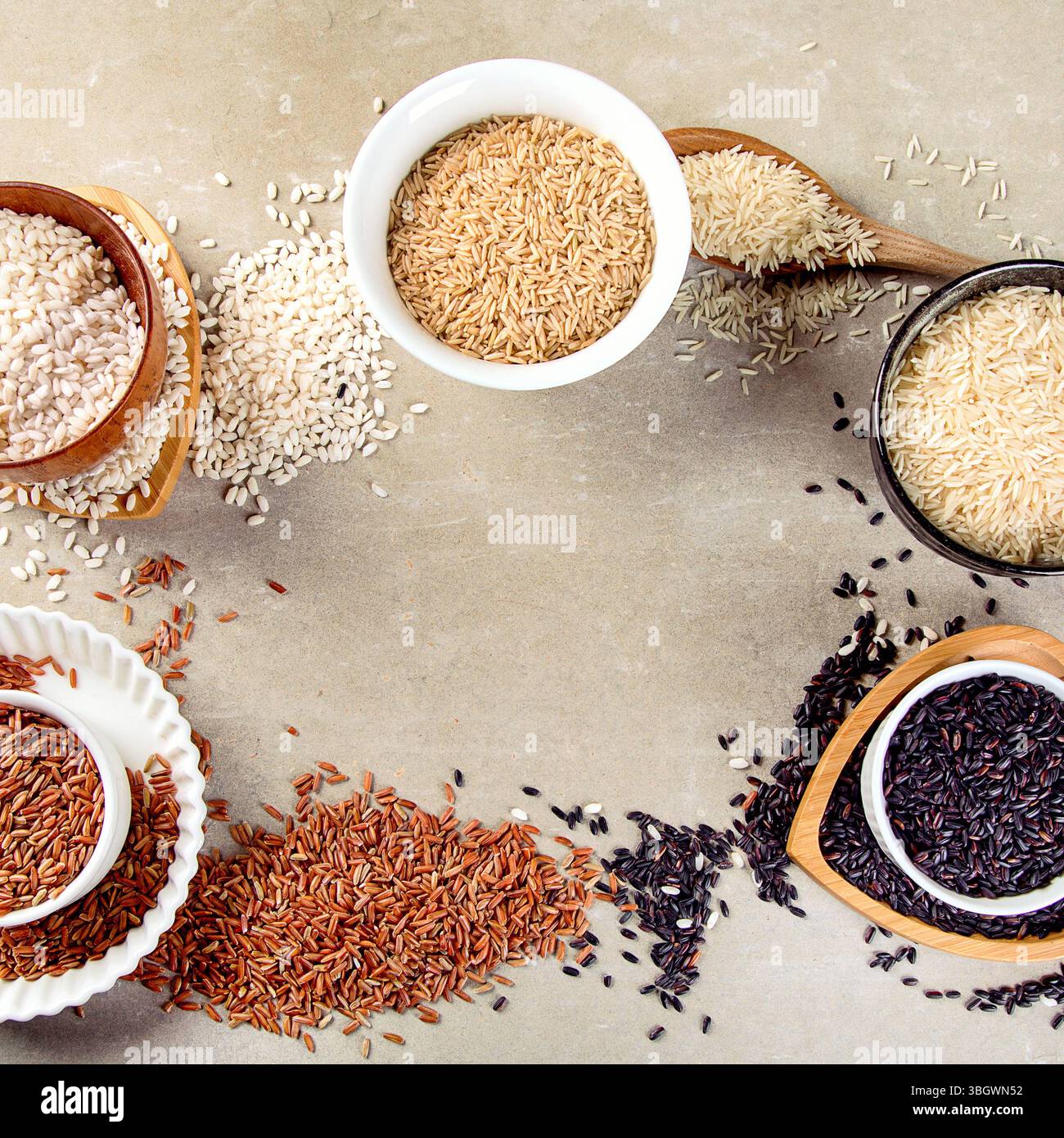 Different kinds of rice grains on a grey background. Top view Stock ...