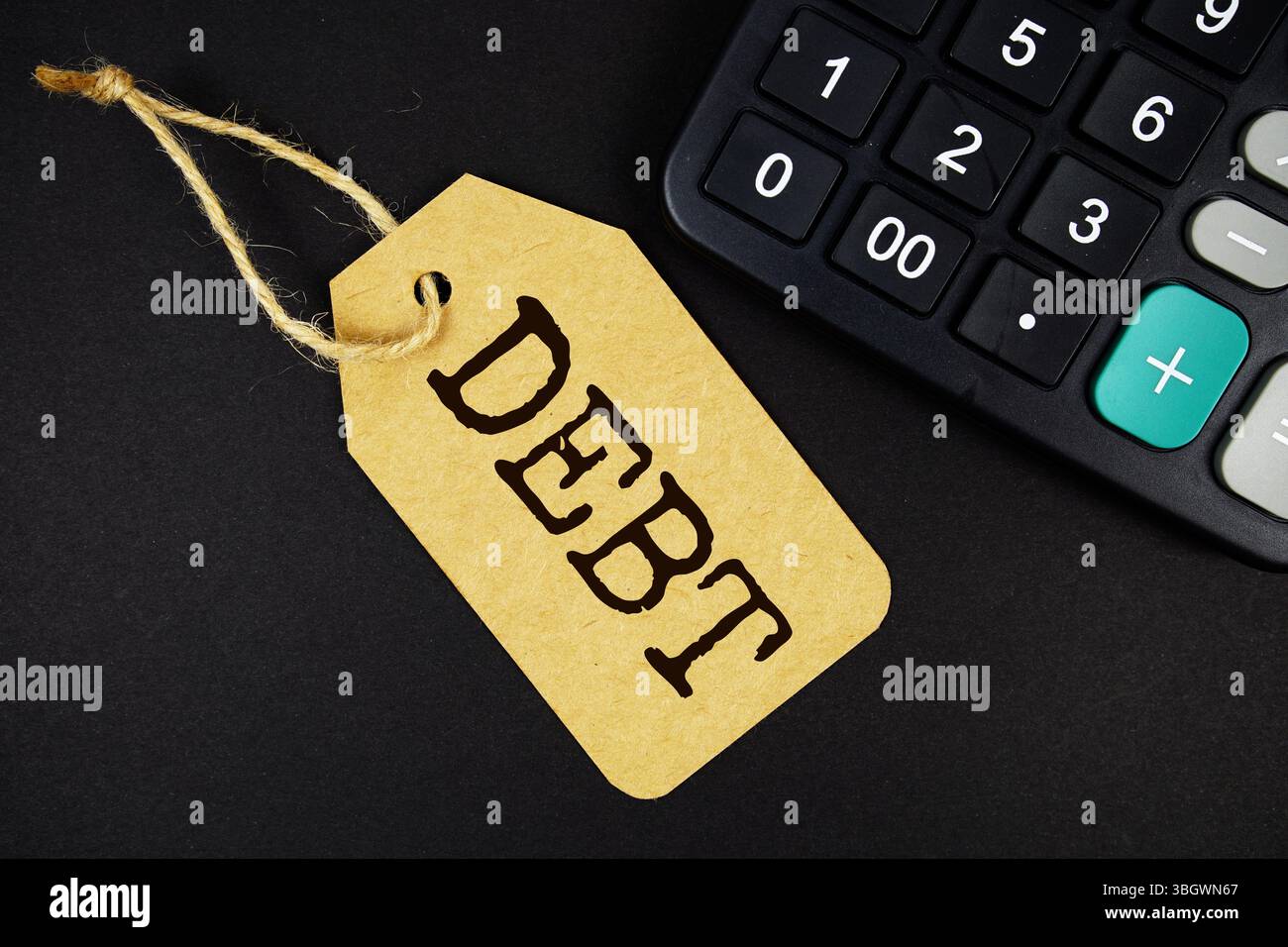 Debt text on price tag with calculator on black background Stock Photo ...