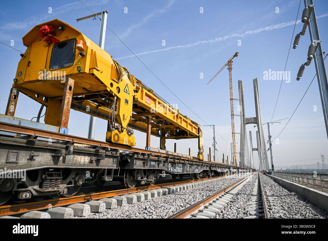 (250606) -- WUHAI, June 6, 2025 (Xinhua) -- A steel rail laying machine ...