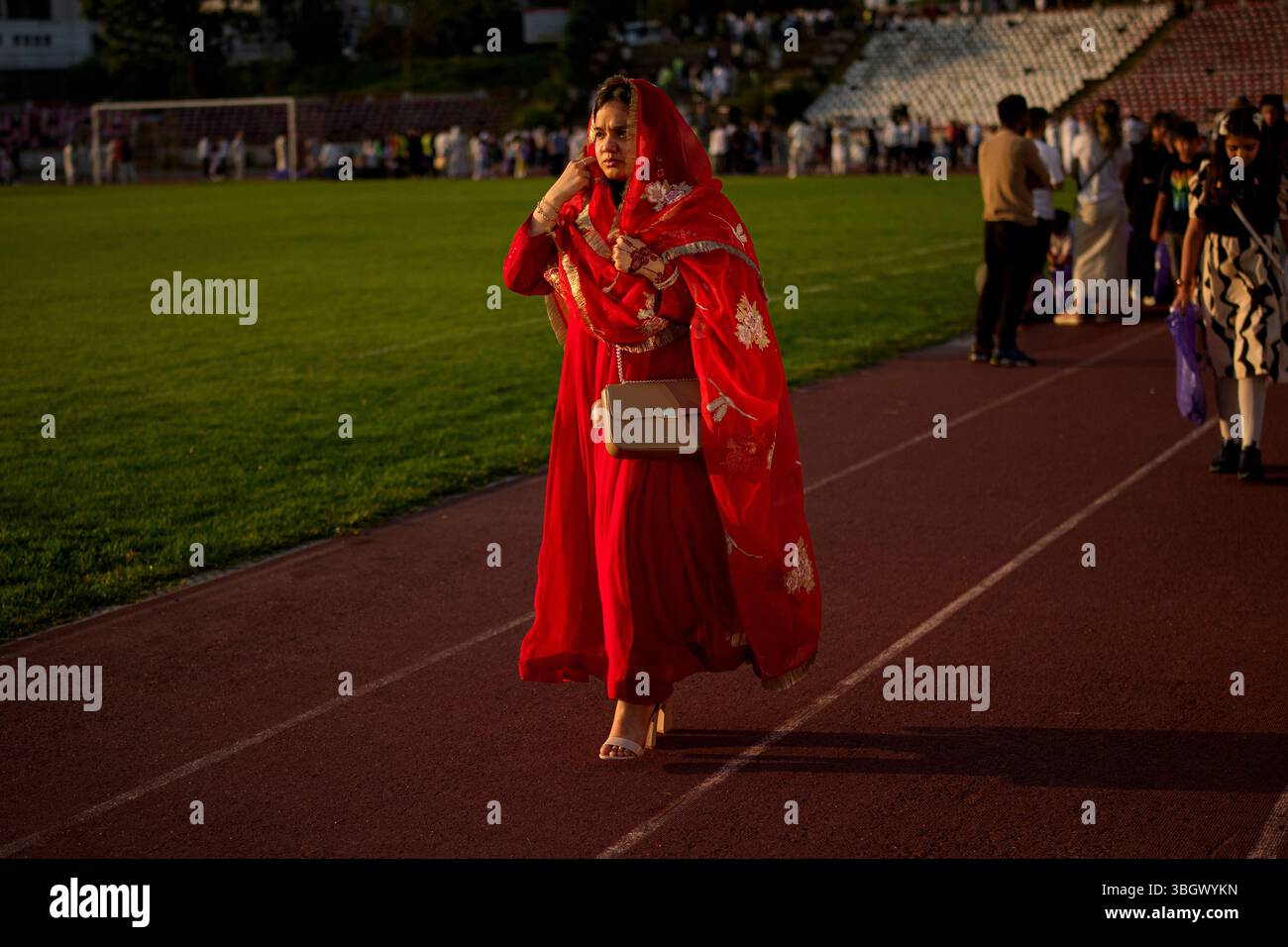 A woman arrives for Eid al-Adha prayers at the Dinamo stadium in ...