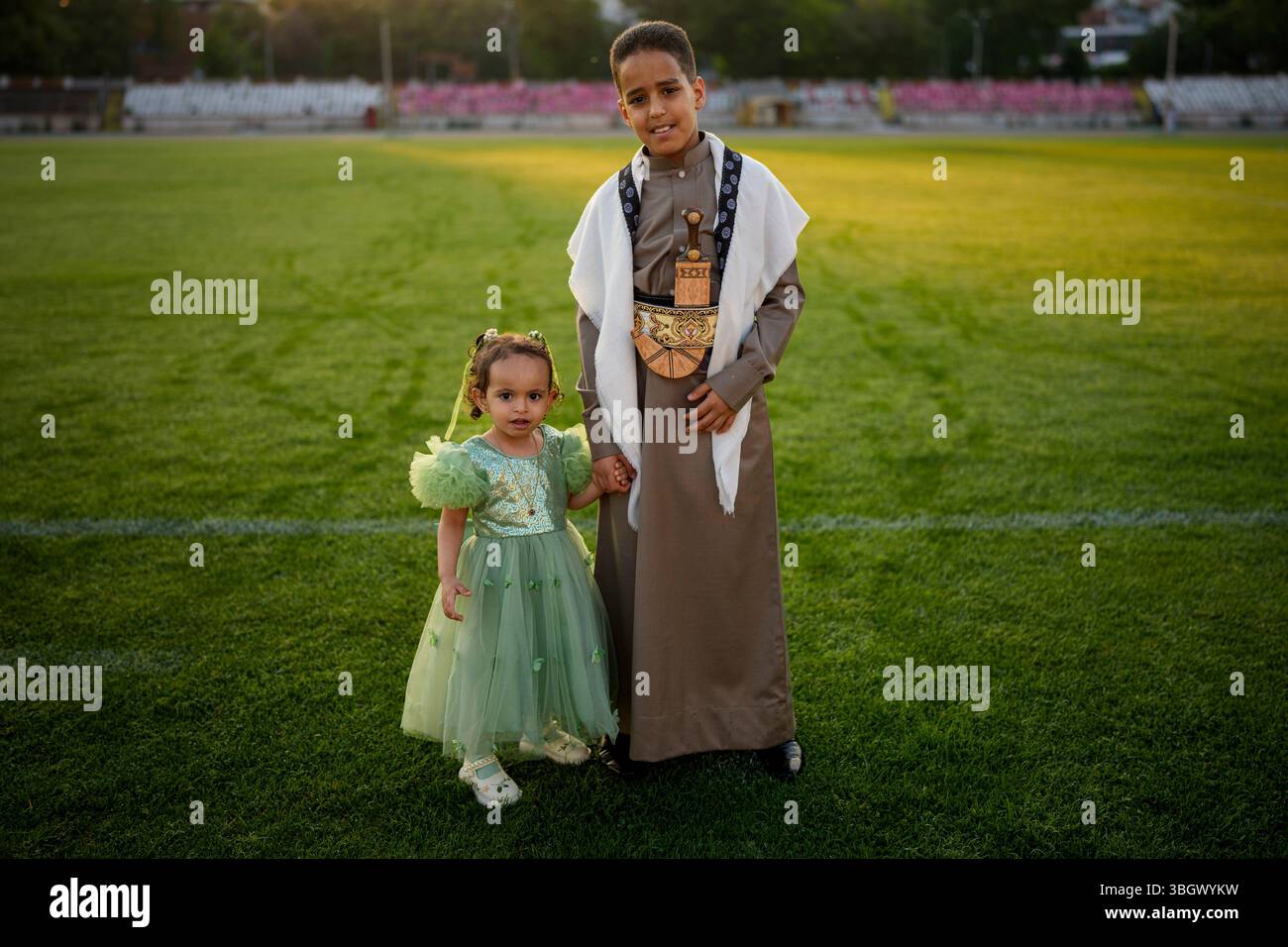 Juman, two and a half years old, poses with her brother Masharai, 12 ...