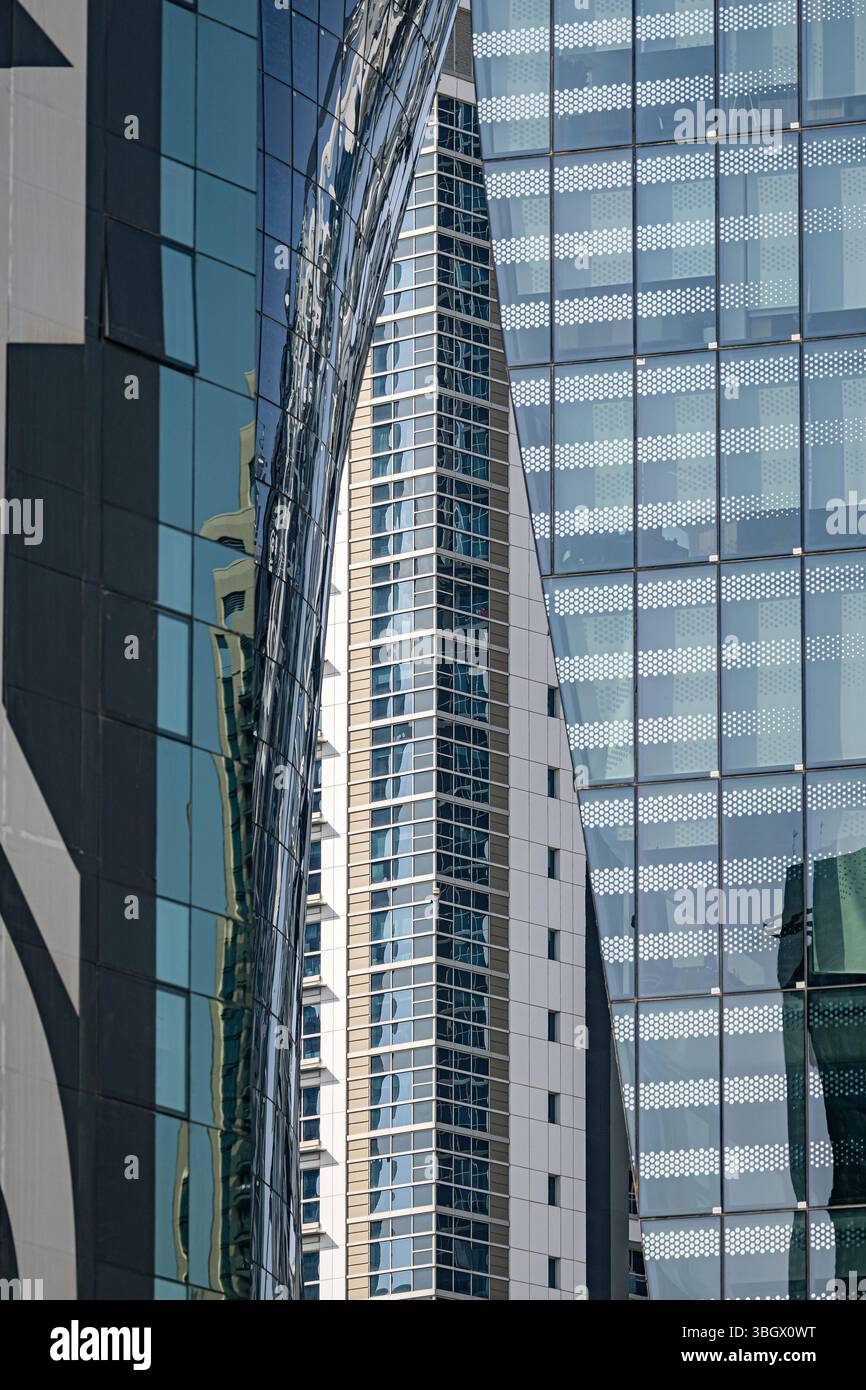 Different glass walls of buildings located close to each other ...