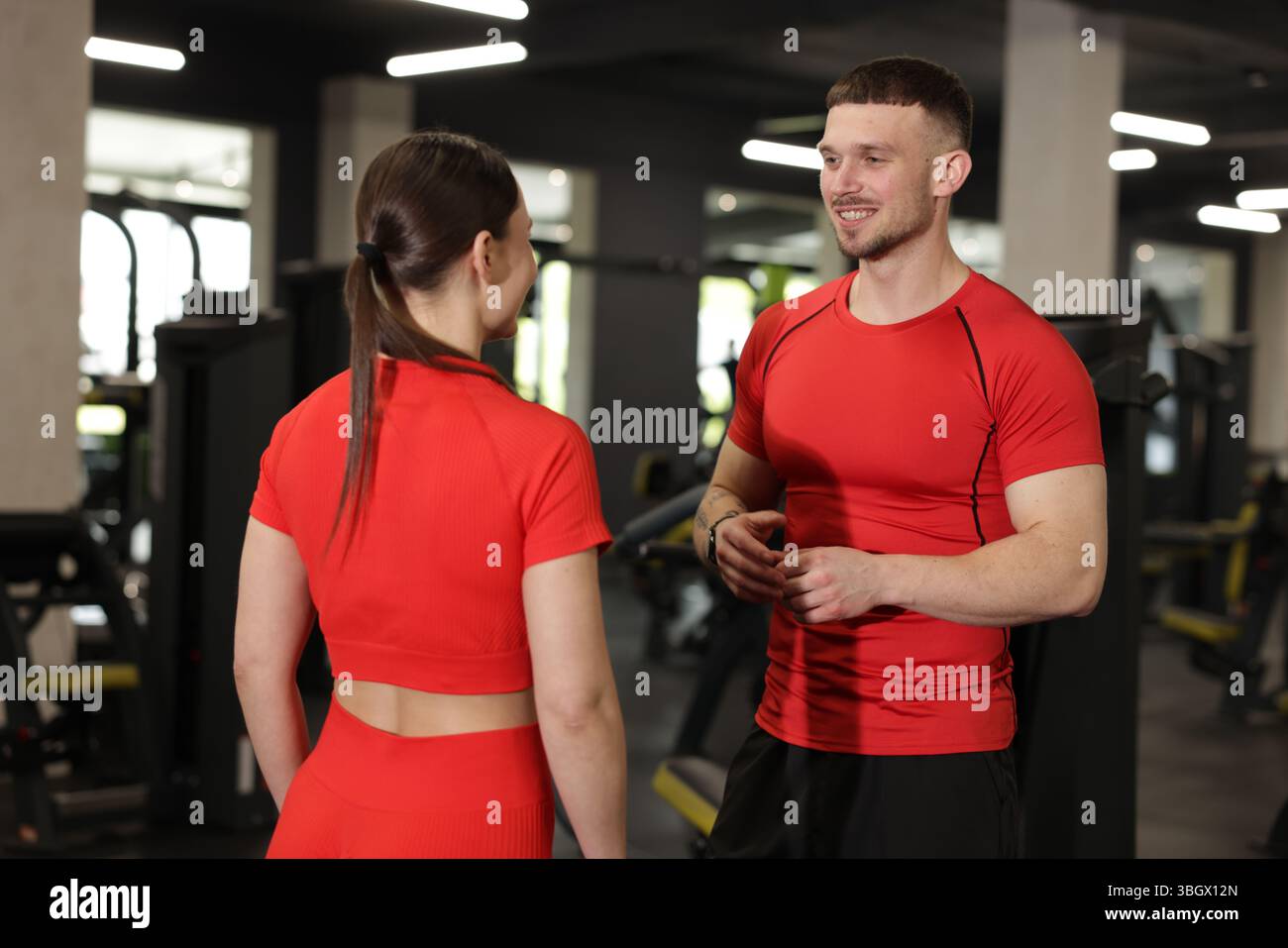 Professional personal trainers talking in sport center Stock Photo - Alamy
