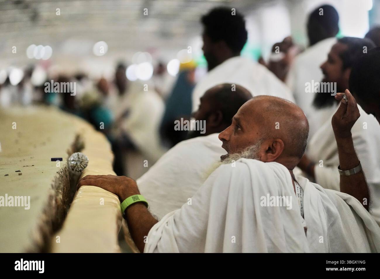 A Muslim pilgrim casts stones at a pillar in the symbolic stoning of ...