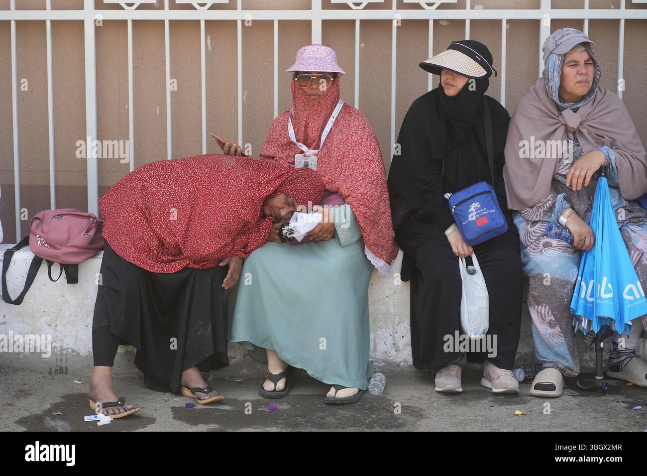 A Muslim pilgrim take a nap on her colleague after they cast stones at ...