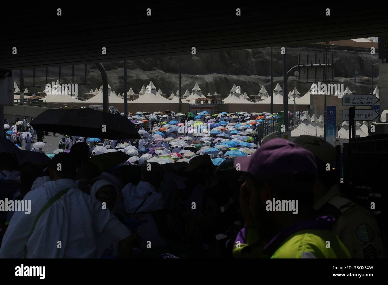 Muslim pilgrims walk on their way to cast stones at pillars in the symbolic stoning of the devil ...