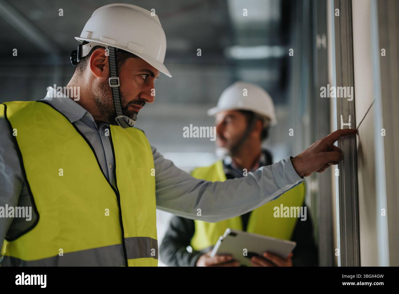 Construction professionals examining structural elements in an ...
