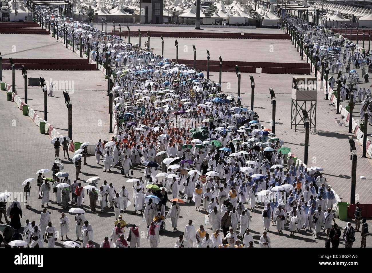 Muslim pilgrims walk on their way to cast stones at pillars in the ...