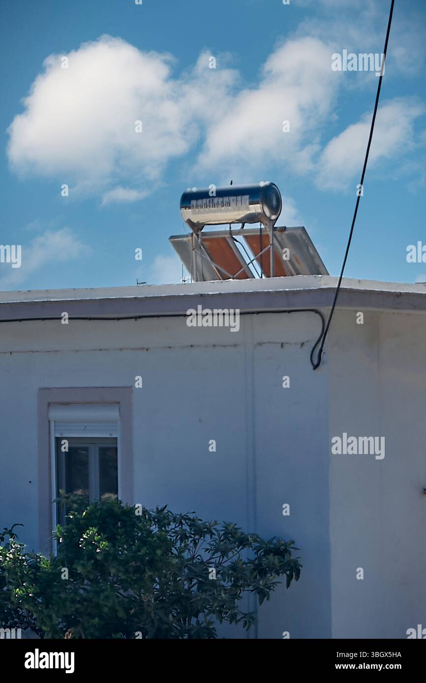 A solar water heater installed on the rooftop of a building demonstrating the commitment to ...