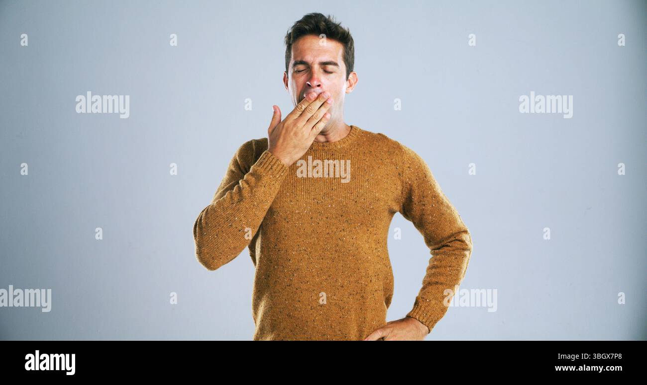 Hand, yawn and tired man in studio with burnout, low energy or ...