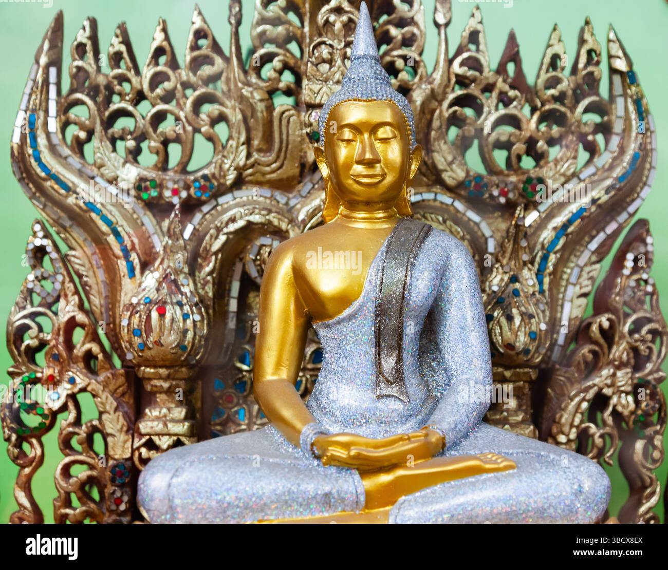 Gilded figure of Buddha on a throne Stock Photo - Alamy