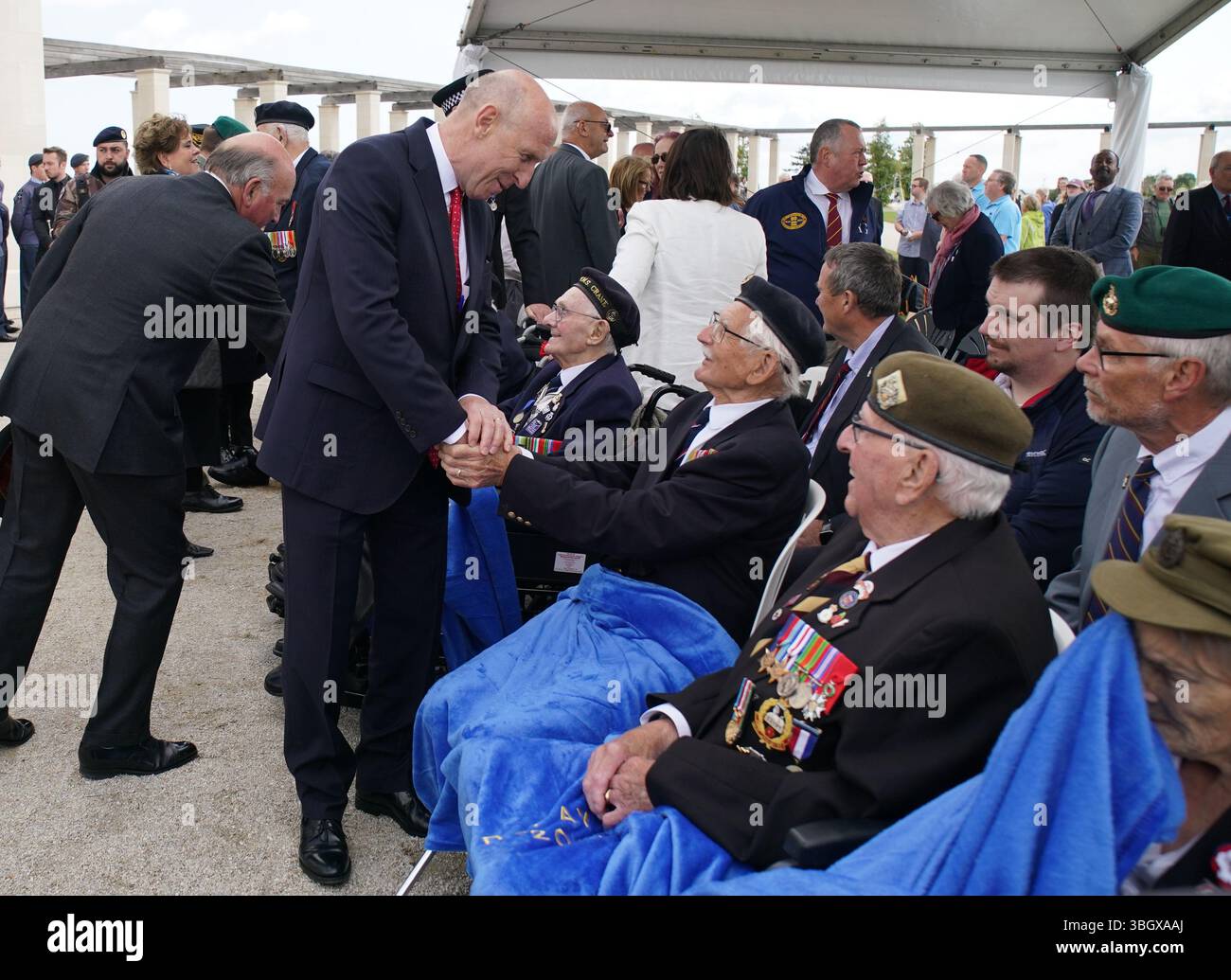 Secretary John Healey (second left) shakes hands with Royal Navy D-Day ...