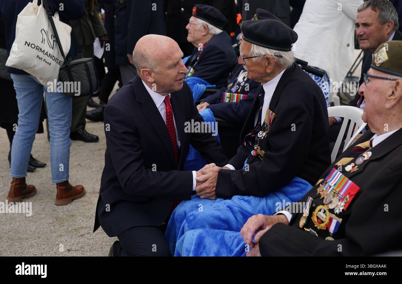 Secretary John Healey (left) shakes hands with Royal Navy D-Day veteran ...