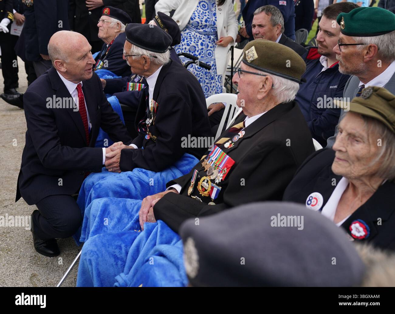 Secretary John Healey (left) shakes hands with Royal Navy D-Day veteran ...