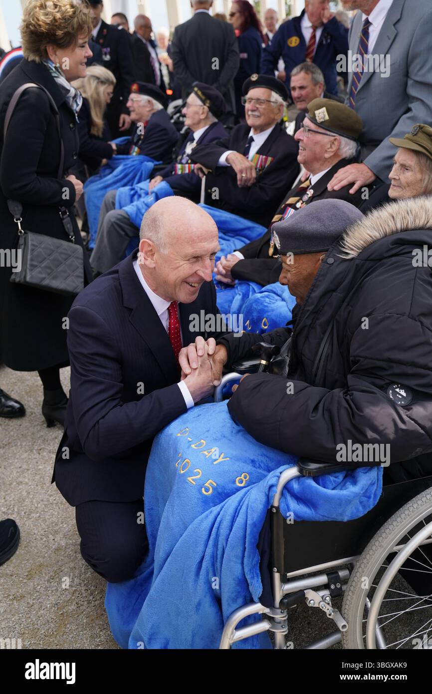 Secretary John Healey (left) shakes hands with RAF veteran Gilbert ...