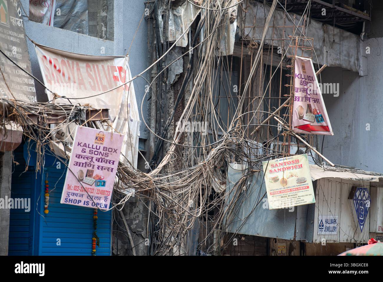 Messy chaotic wires and cables on house wall, Mumbai, India, telephone ...
