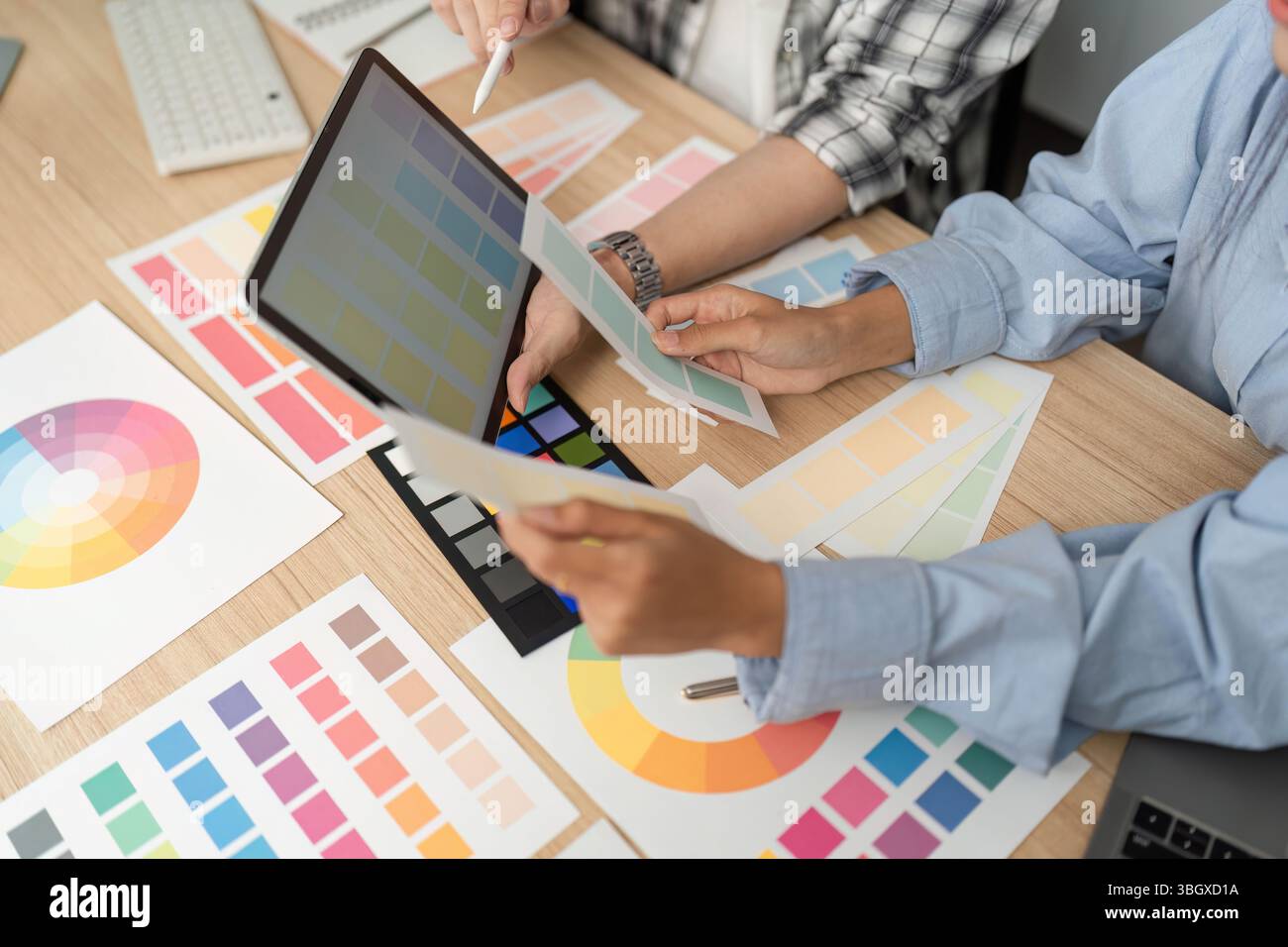 UX and UI Design Review. Designers analyzing color palettes and digital ...