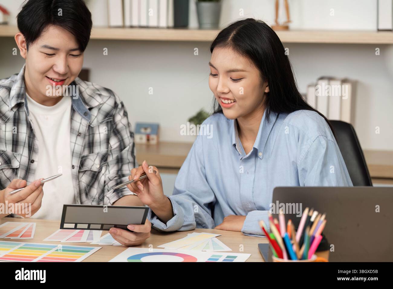 UX and UI Design Collaboration. Two designers discussing color palettes ...