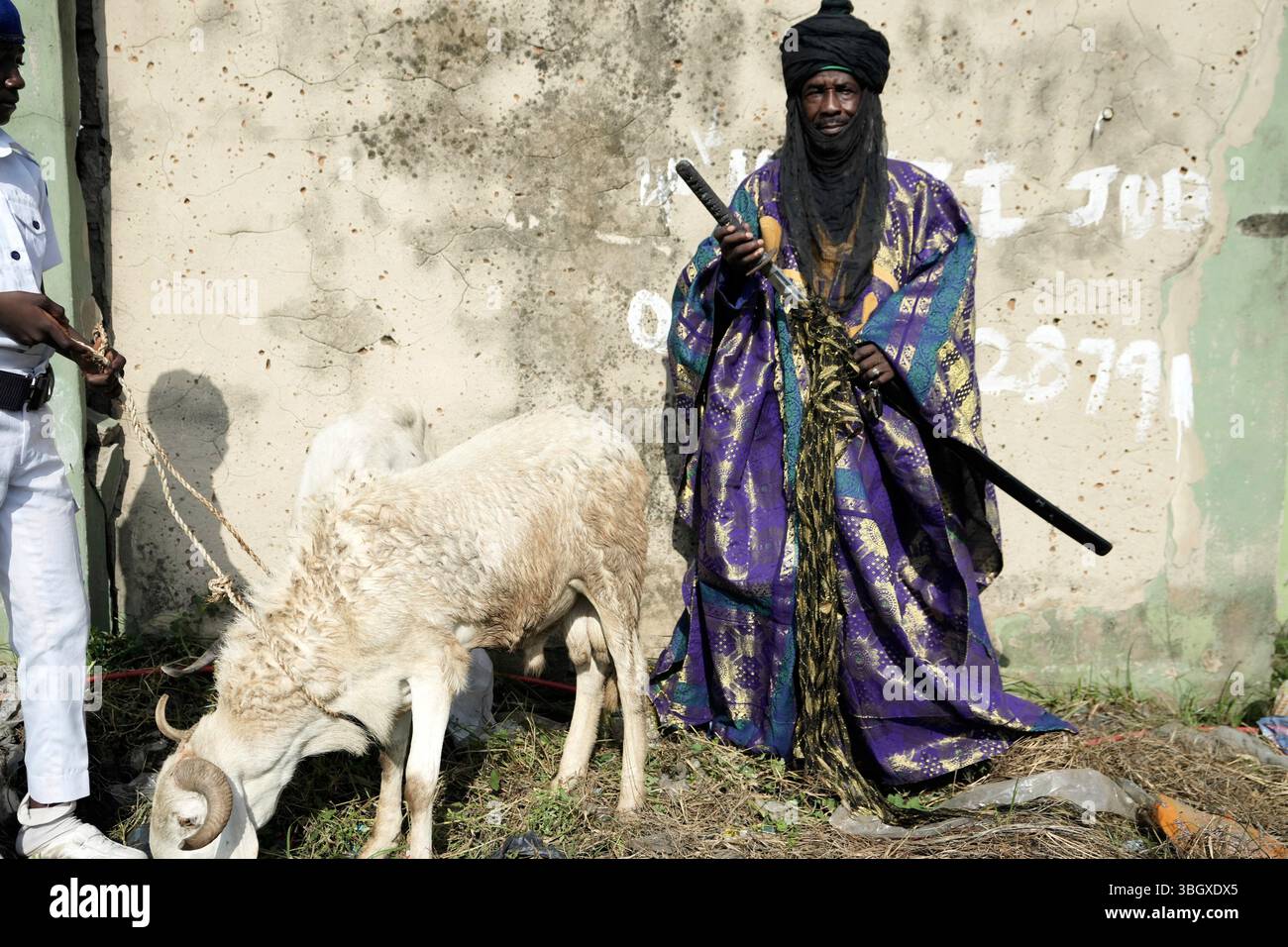 A Nigerian Muslim man in traditional dress poses for photographs in ...