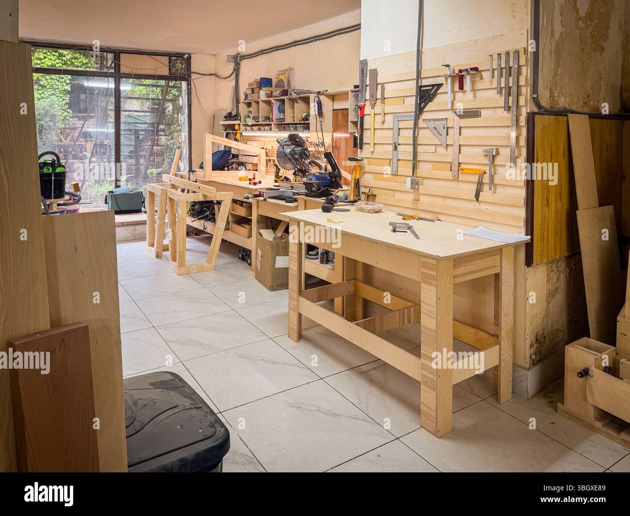 Professional woodworking station with benches, mounted tools, clamps ...