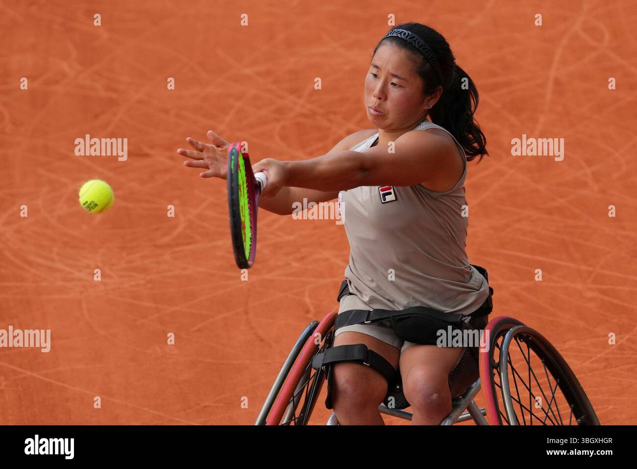 Japan's Yui Kamiji plays a shot against China's Xiaohui Li during their women's wheelchair ...