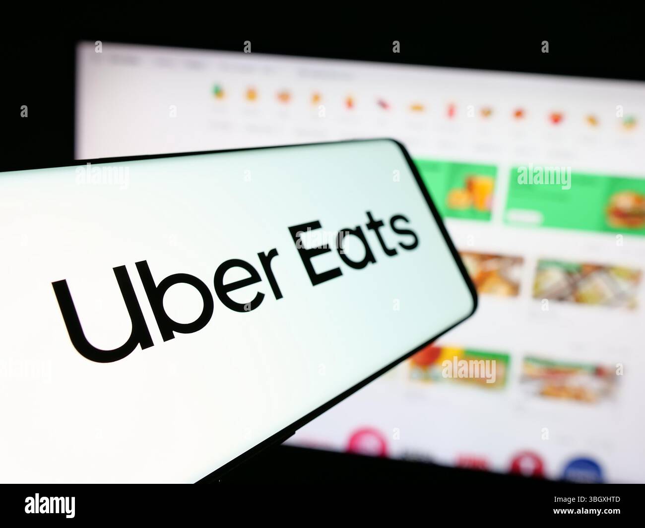 Stuttgart, Germany - 03-12-2025: Smartphone with logo of US online food delivery company Uber ...