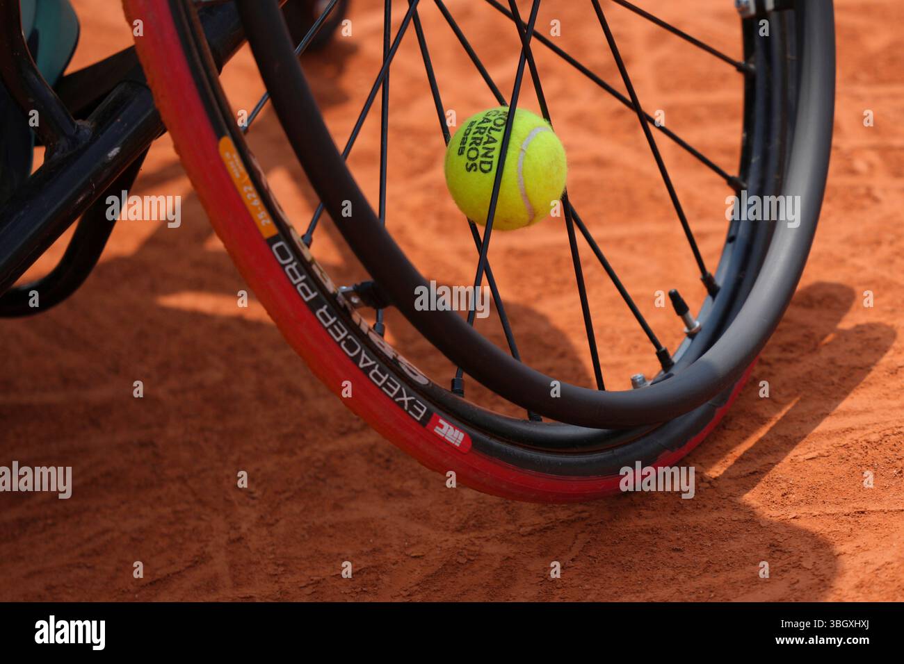 A tennis ball stuck in the spokes of the wheel of China's Xiaohui Li as she plays against Japan ...