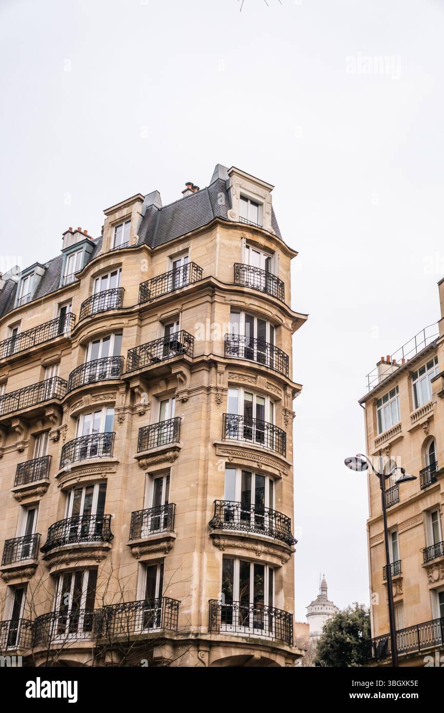 A low-angle view of a classic Parisian apartment building, showcasing ...