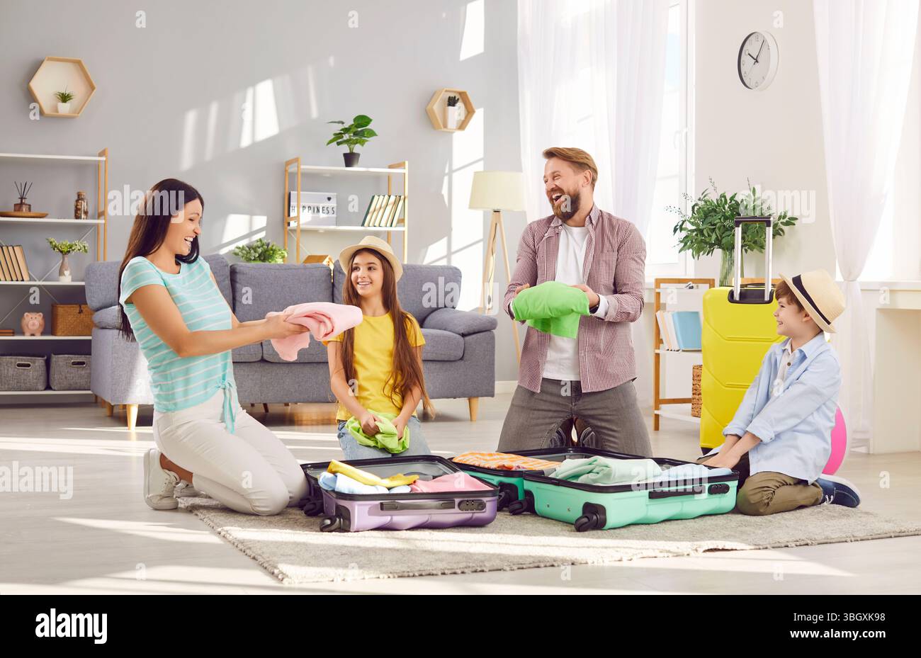 Happy family packing suitcases preparing for summer vacation trip ...