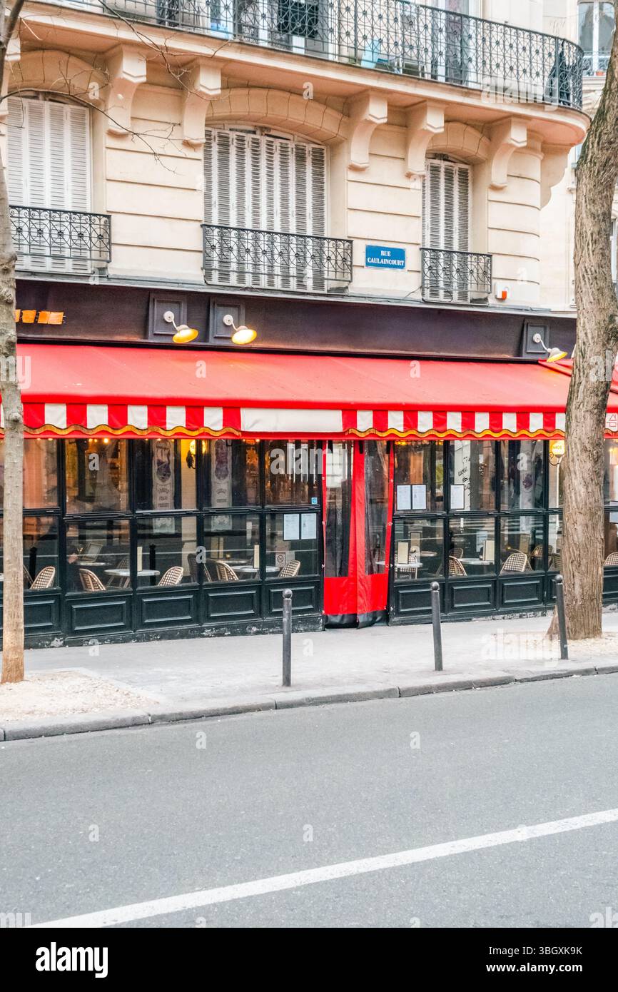 The exterior of a traditional Parisian cafe featuring a large red and ...