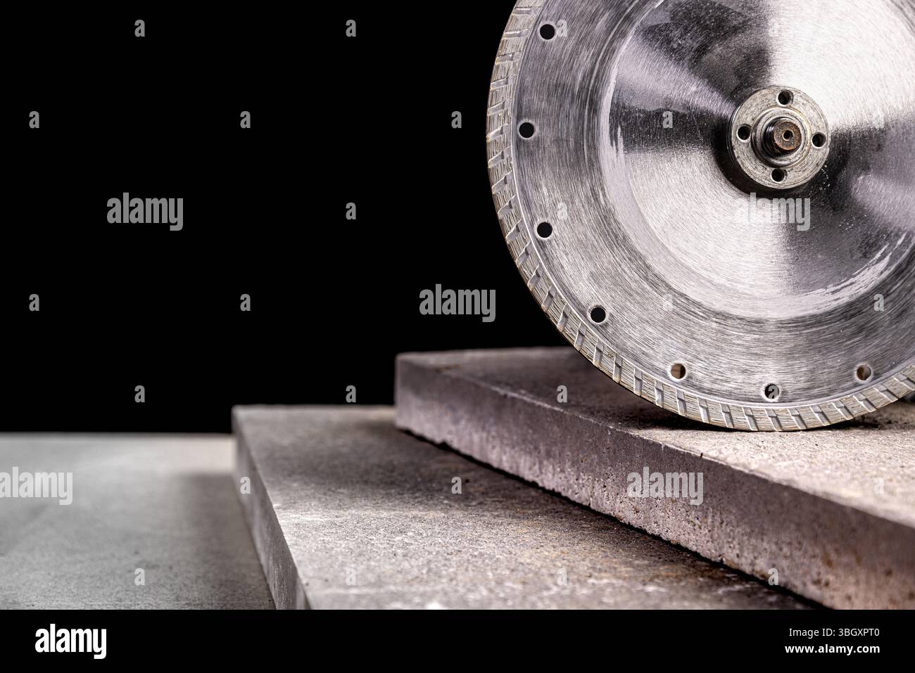 Diamond circular saw blade cutting concrete tiles black background ...