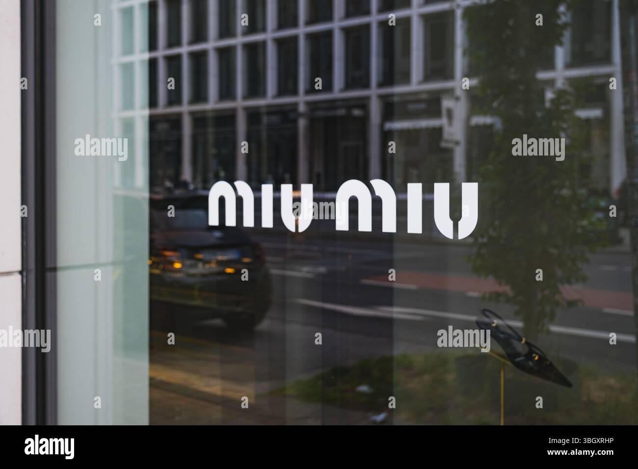 MIU MIU luxury brand logo on the shop window with shoe on display in ...