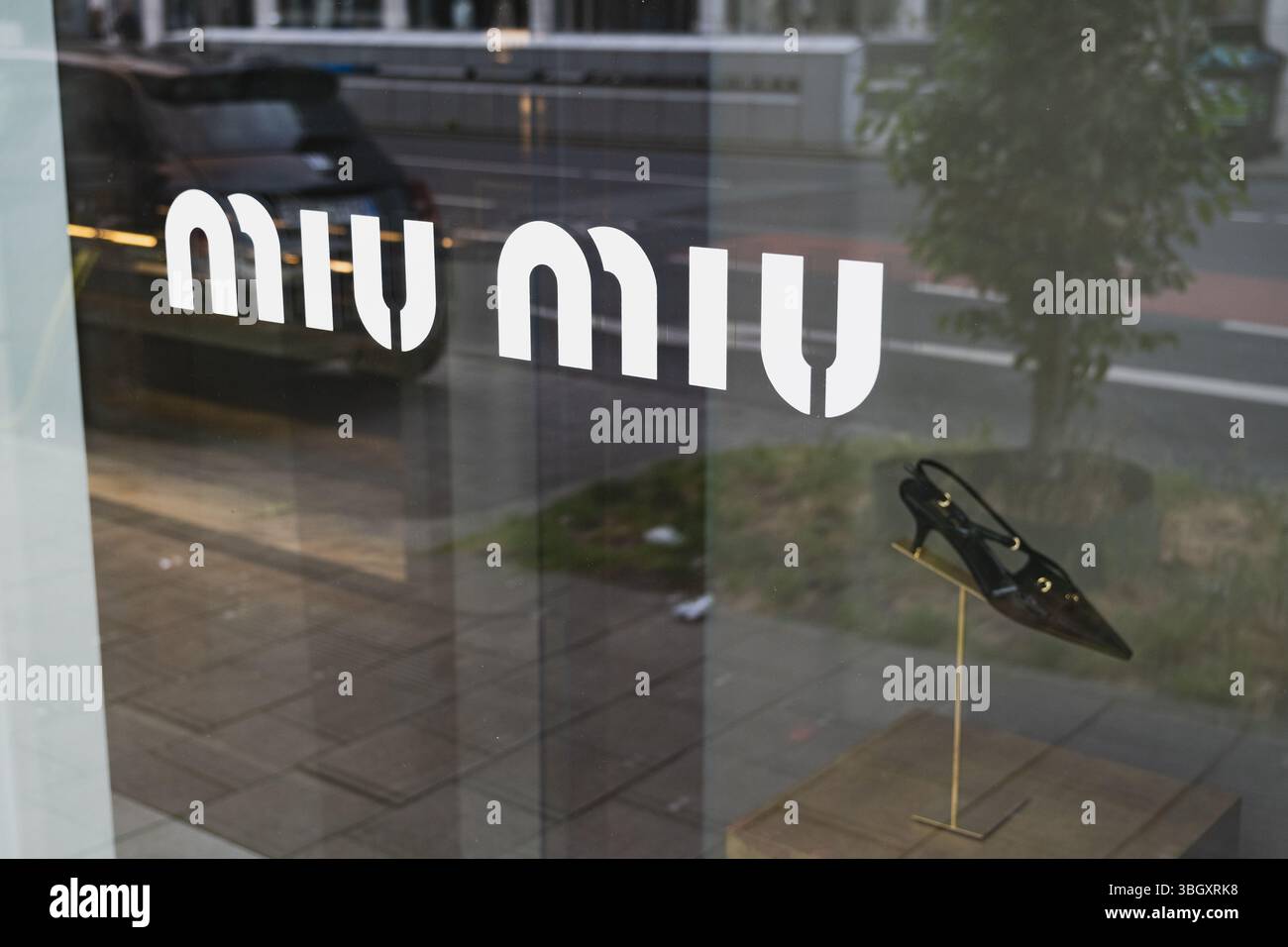 MIU MIU luxury brand logo on the shop window with shoe on display in ...