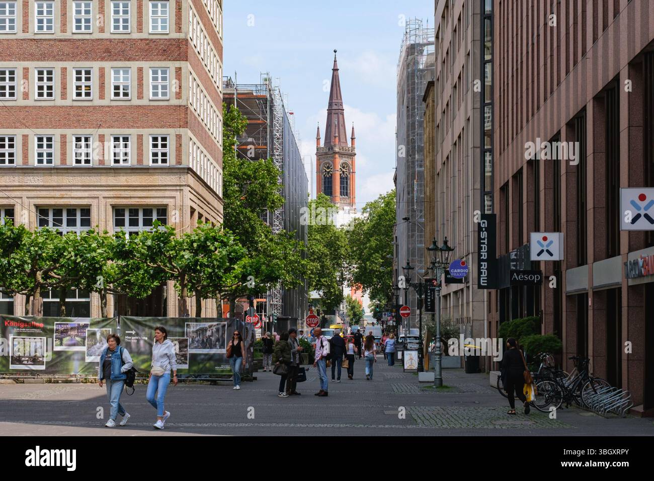 People enjoy shopping along a lively city street with boutiques Stock ...