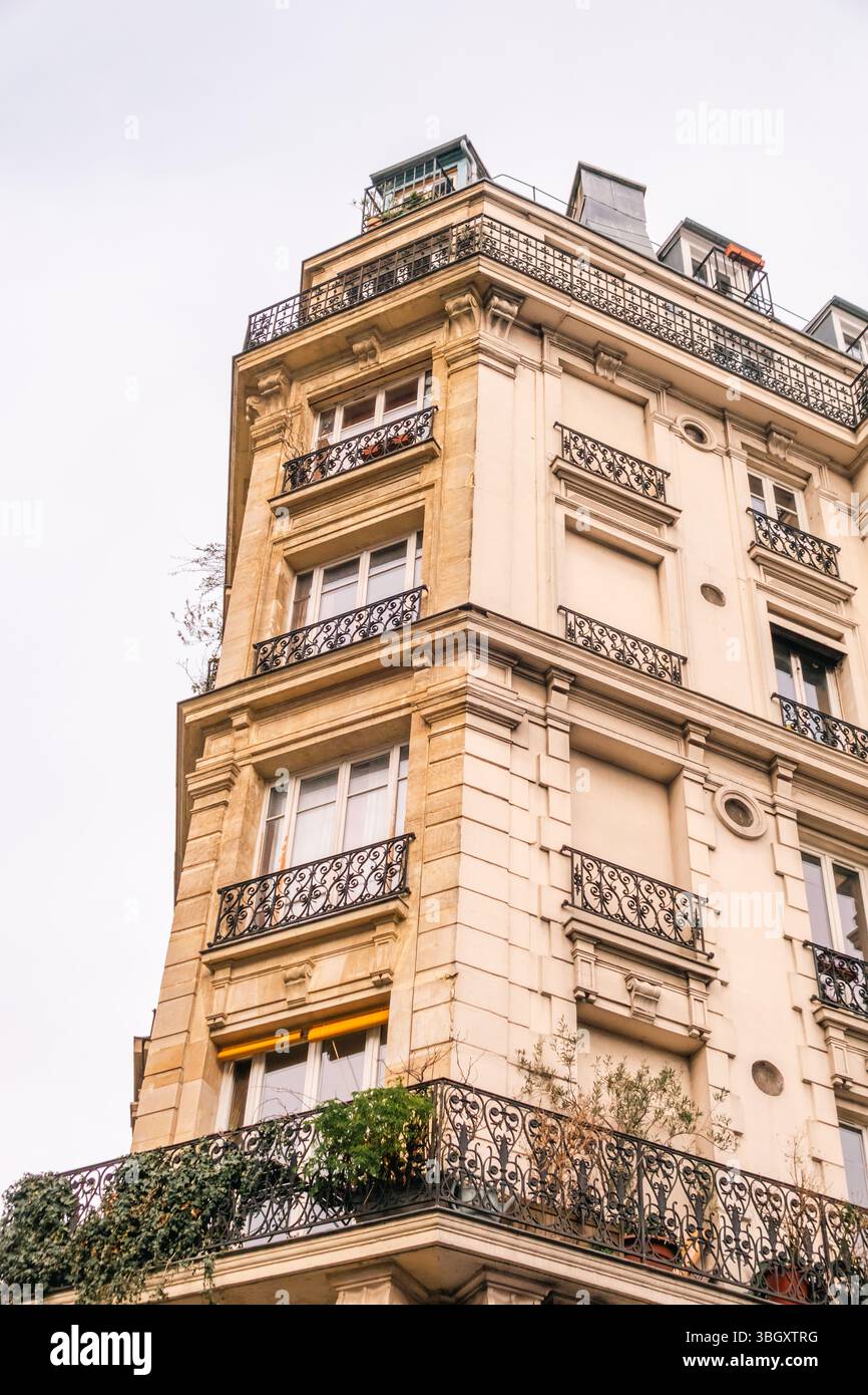 A low-angle corner view of a classic Parisian apartment building ...
