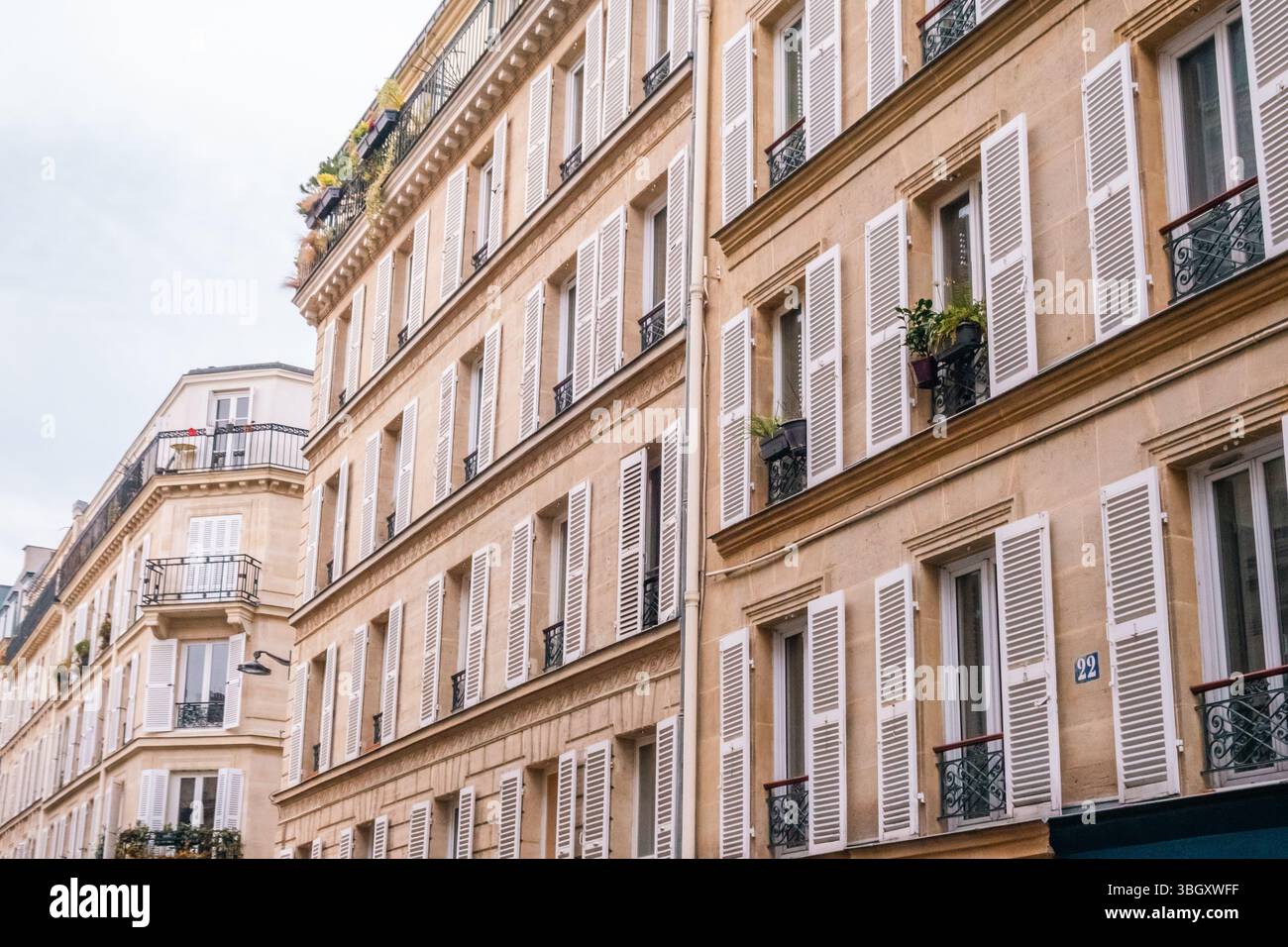 A row of classic Parisian apartment buildings with traditional stone ...