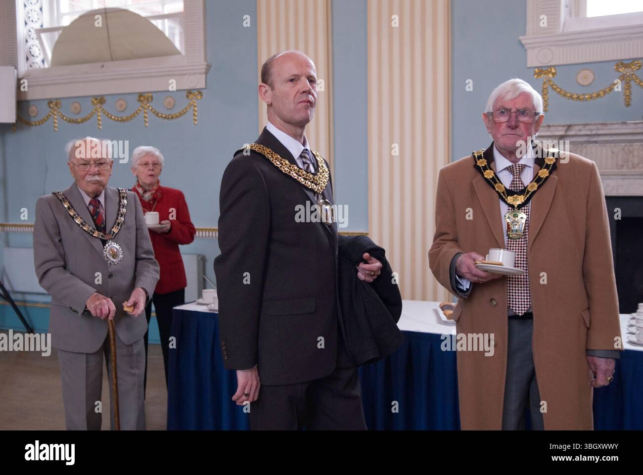 Ill at ease at an official reception. Group of local mayors wearing ...